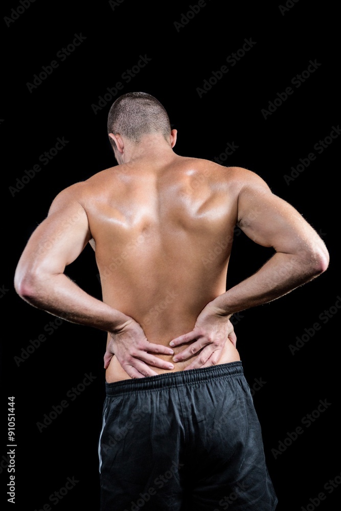 Shirtless man touching back Stock Photo | Adobe Stock