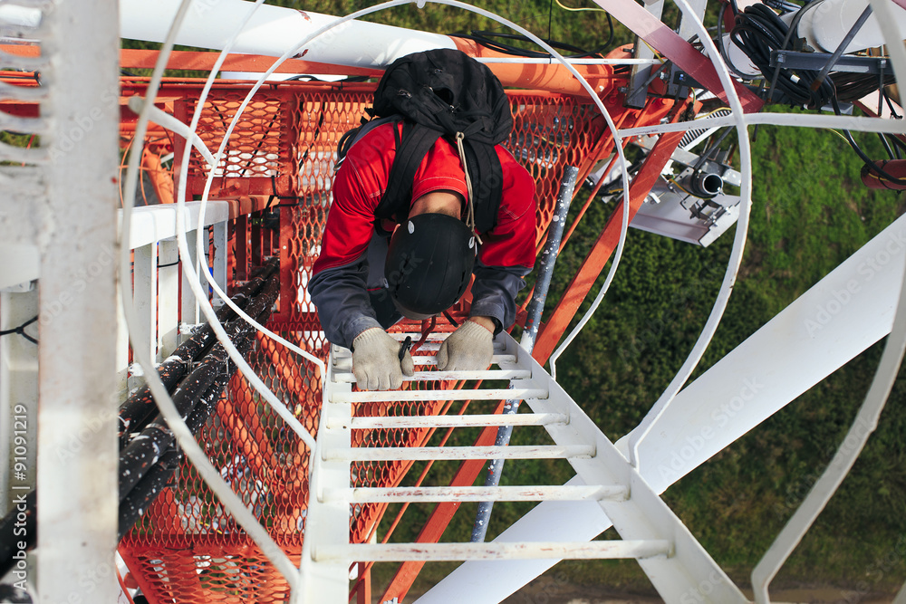 Industrial climber down from telecommunications tower. Industrial ...