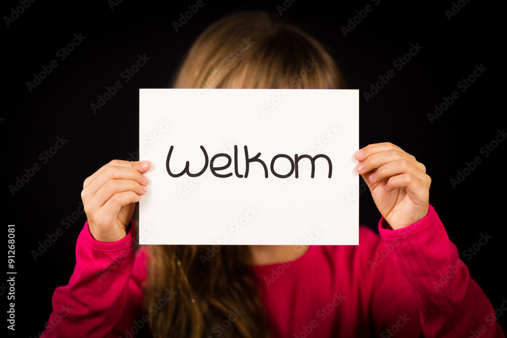Child holding sign with Dutch word Welkom - Welcome Stock Photo | Adobe ...