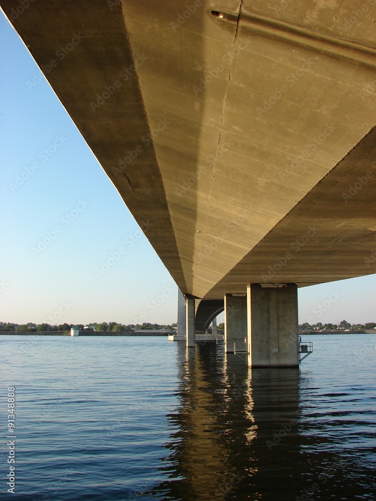 Underside of bridge with columns and water reflections Stock Photo ...