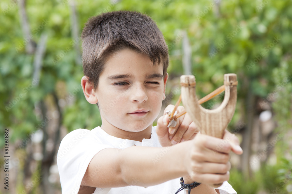 boy with slingshot outdoors Stock Photo | Adobe Stock