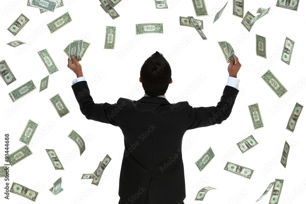 Raining money on a celebrating business man behind view Stock Photo ...