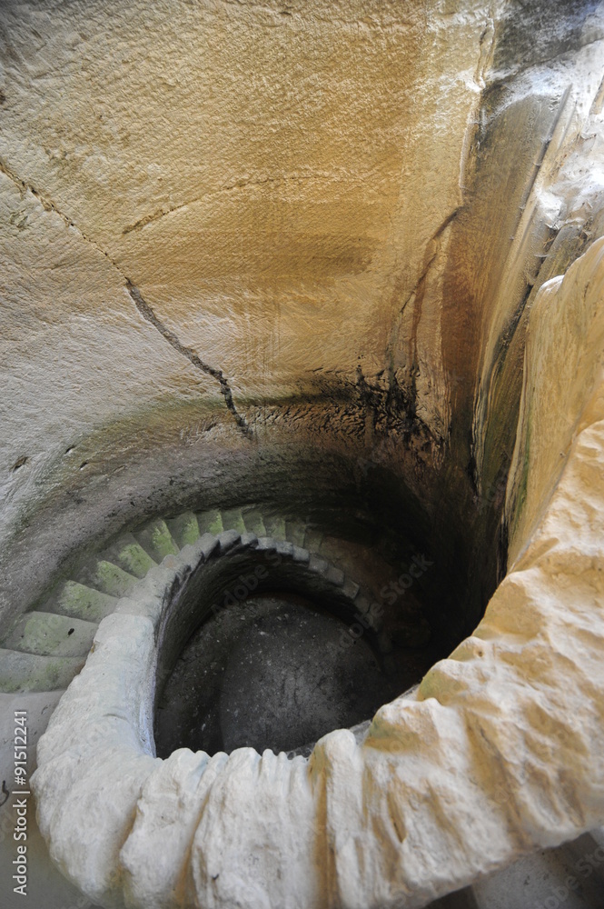 Underground passage in the cave with a spiral stone stairs Stock Photo ...