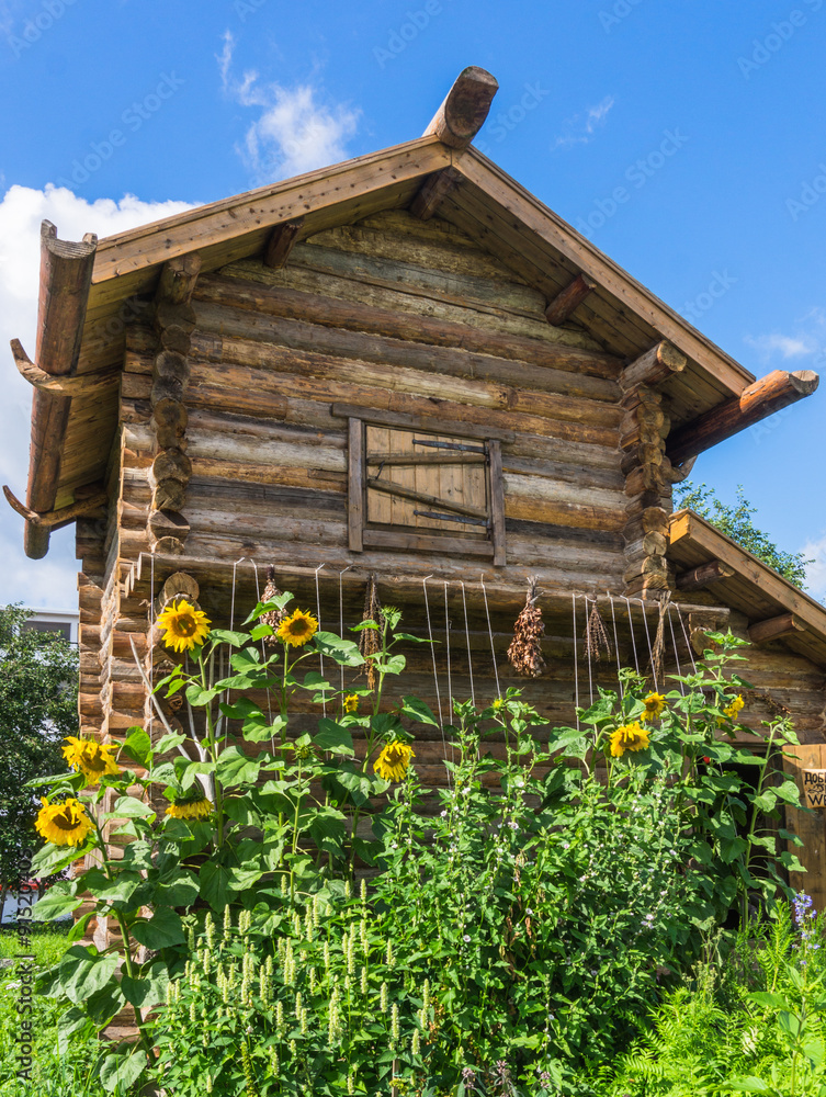 log two story log shop selling herbs with sunflowers and drying herbs ...