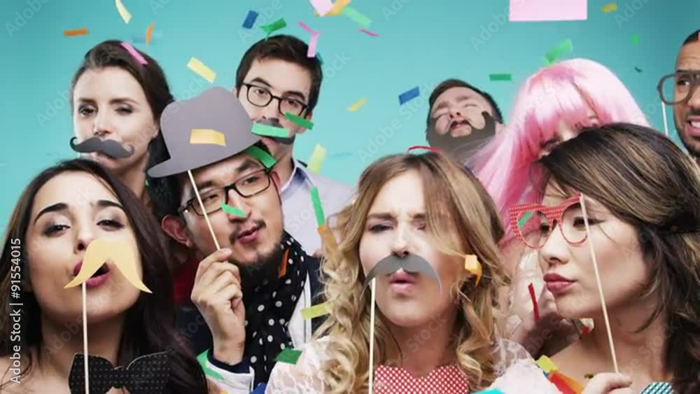 Multi racial group of funny people celebrating slow motion party photo ...