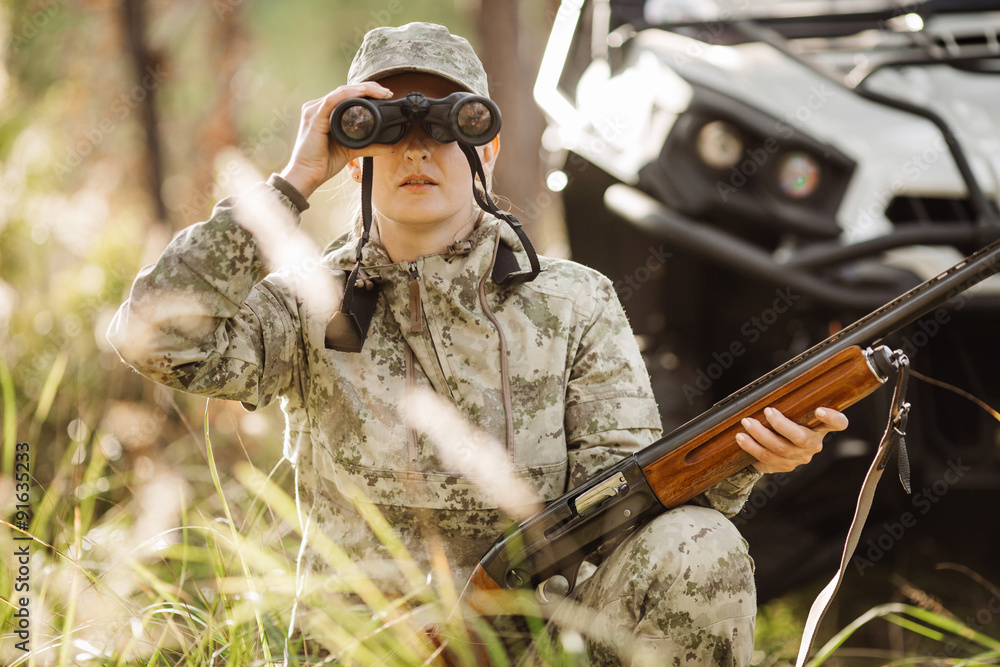 hunter with shotgun looking through binoculars in forest Stock Photo ...