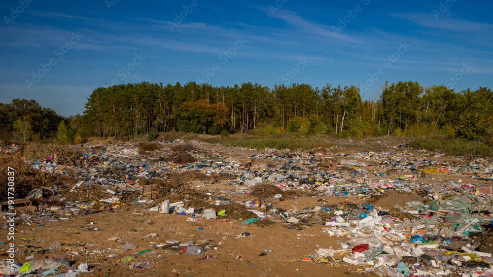 Pile of garbage in front of green trees Stock Photo | Adobe Stock