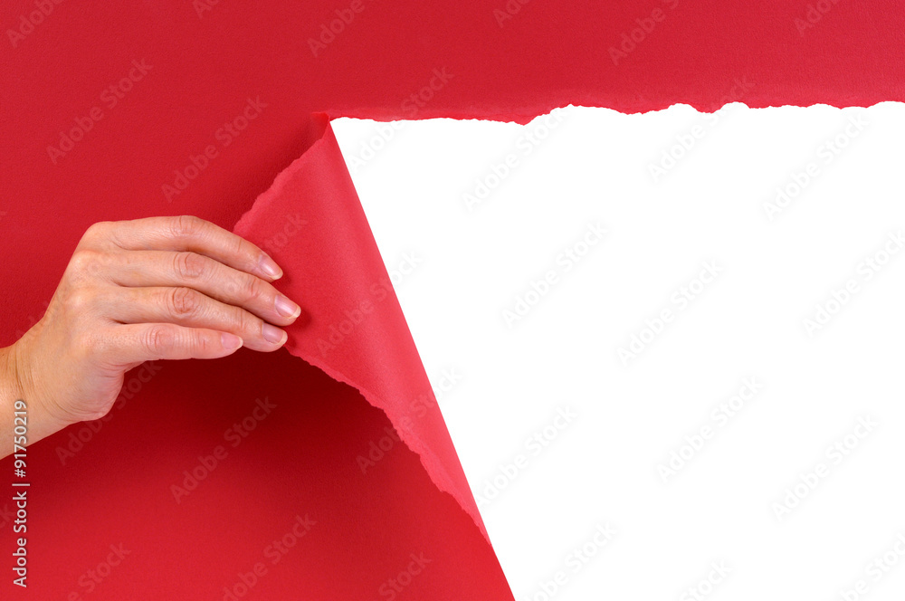Hand tearing red paper background open opening revealing white space ...
