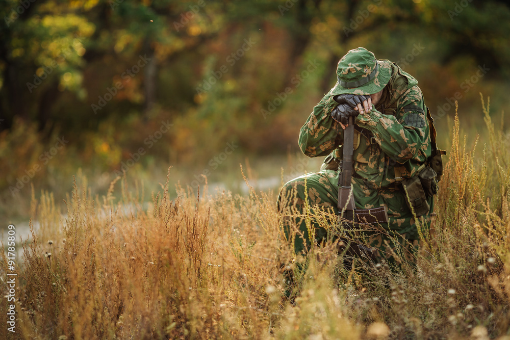 Sad solider sitting with a gun Stock Photo | Adobe Stock