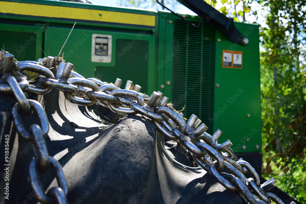 Stockfoto Studded Chains on Log Skidder Tire | Adobe Stock