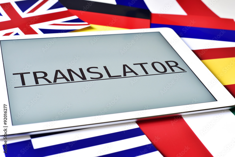 different flags and the word translator in the screen of a table Stock ...