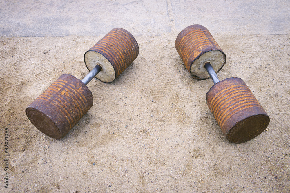 Homemade Brazilian dumbbell weights made from concrete inside rusted ...