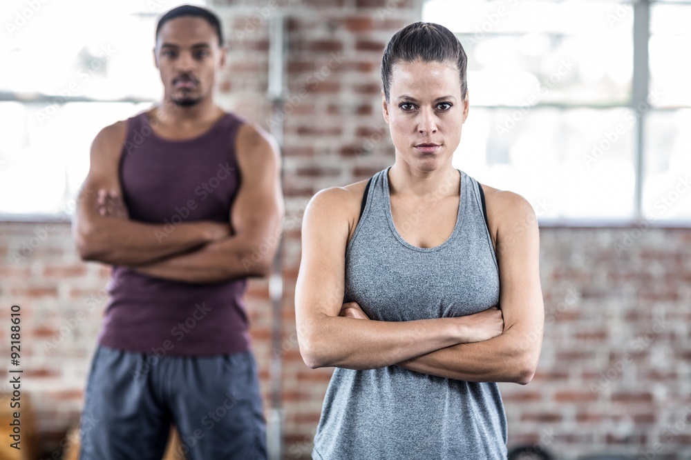 Fit couple posing with arms crossed Stock Photo | Adobe Stock