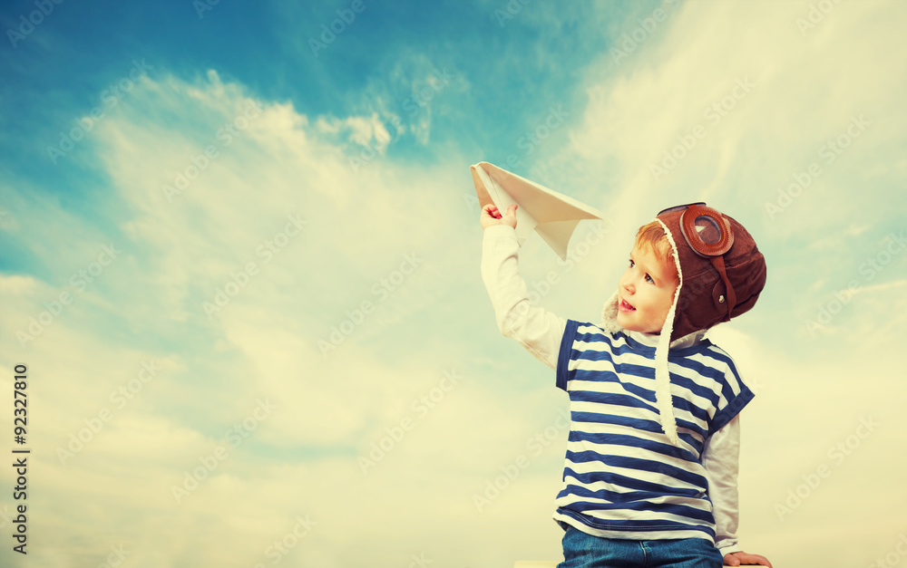 Happy child dreams of becoming pilot aviator and plays with plan Stock ...