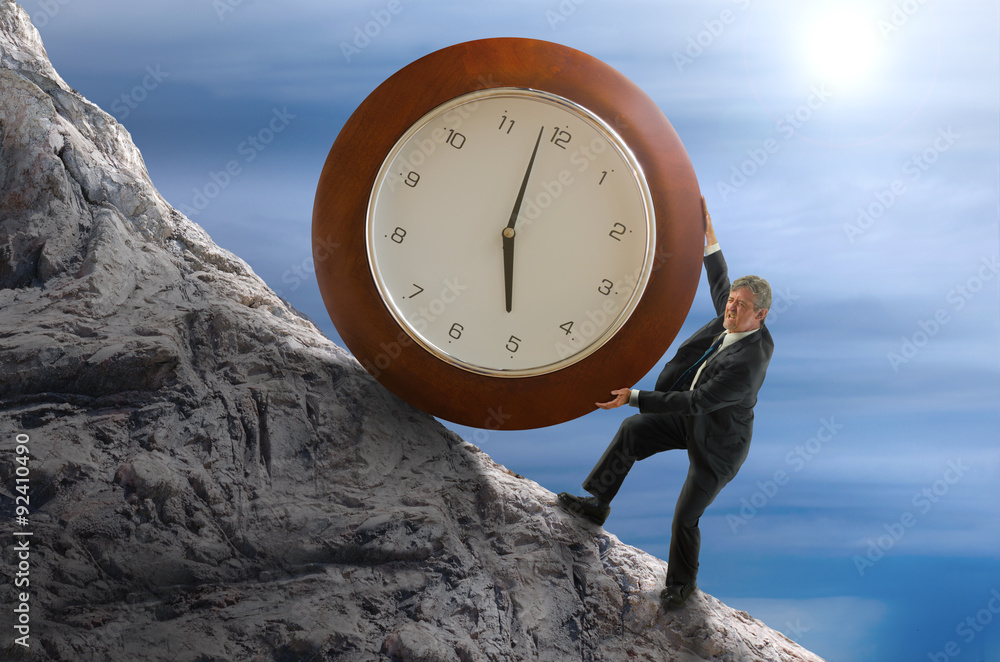 Sisyphus stressed for time man rolling huge clock up a hill Stock Photo ...