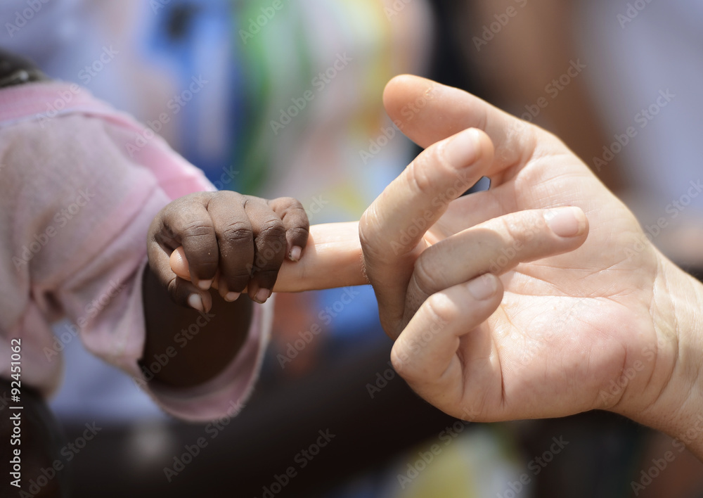 Black Baby and White woman holds hands with a little baby native ...