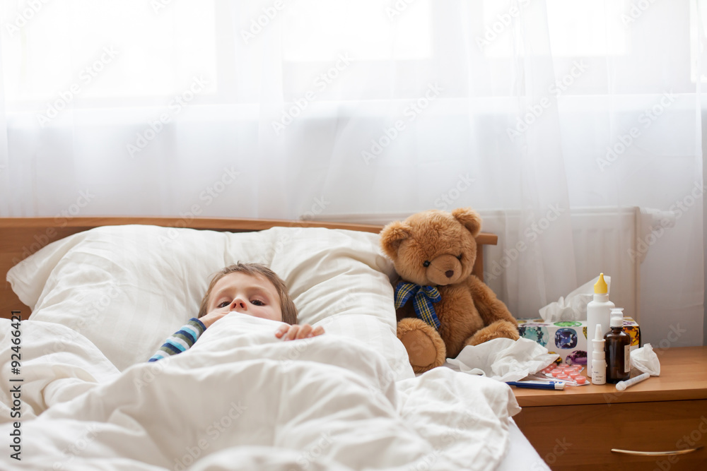 Sick child boy lying in bed with a fever, resting Stock Photo | Adobe Stock