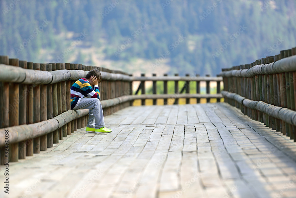sad boy sitting alone Stock Photo | Adobe Stock