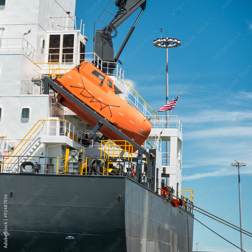 orange free-fall life boat for emergency crew evacuation installed on ...