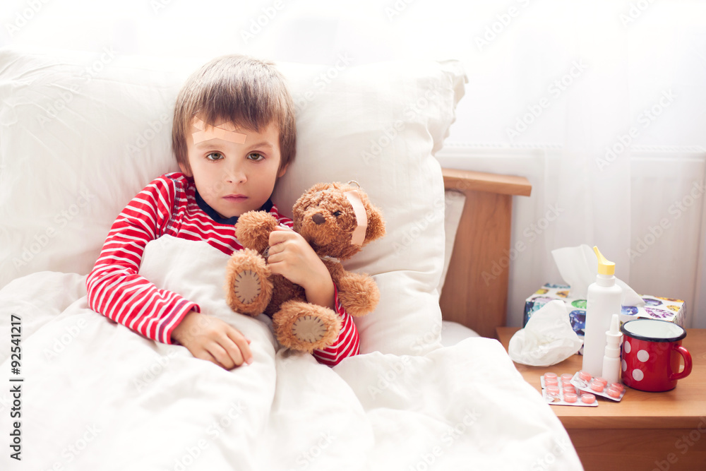 Sick child boy lying in bed with a fever, resting Stock Photo | Adobe Stock