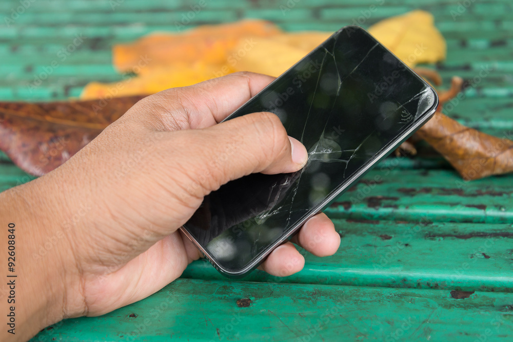 Hands holding and thump up touch on broken mobile smartphone sceen at ...