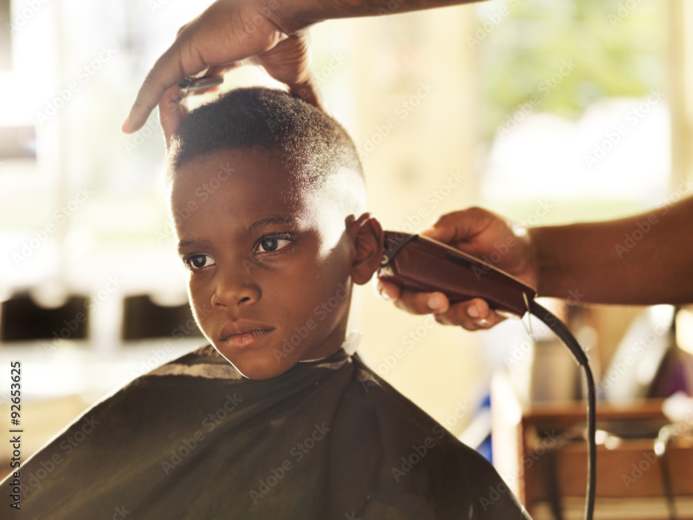 little boy getting his head shaved by barber Stock Photo | Adobe Stock