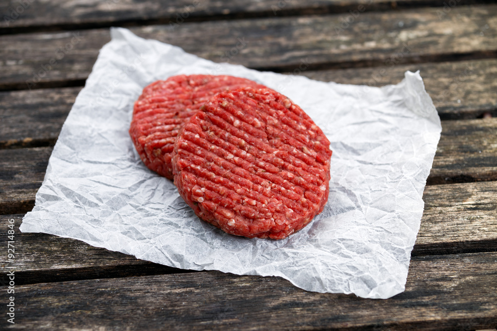 HandMade Minced Beef burger, on crumpled paper. wooden table. Stock ...