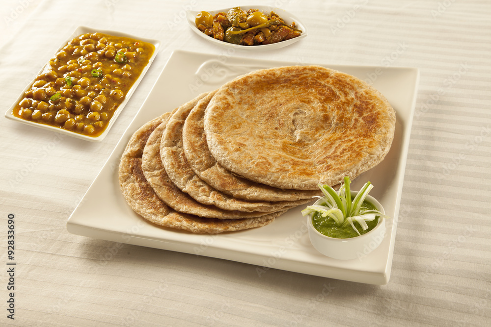 Bran paratha puri served with chickpeas cholay and pickle chutne Stock ...
