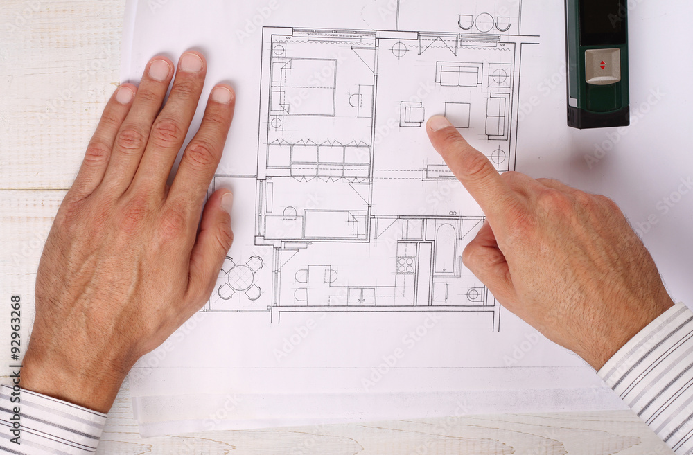 Architect showing project, house plans. Close up on male hand pointing ...