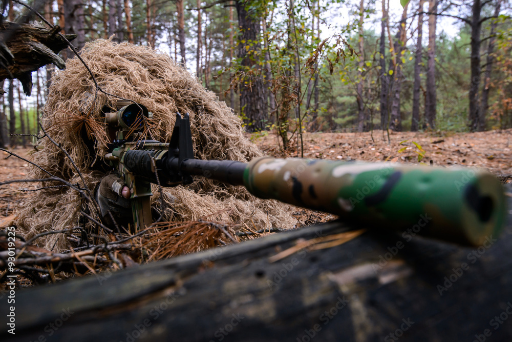Soldier in camouflage suit with sniper rifle in forest/Soldier in ...