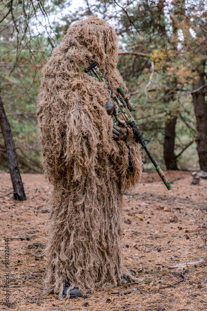 Sniper in camouflage suit with rifle in hands/Sniper standing in forest ...