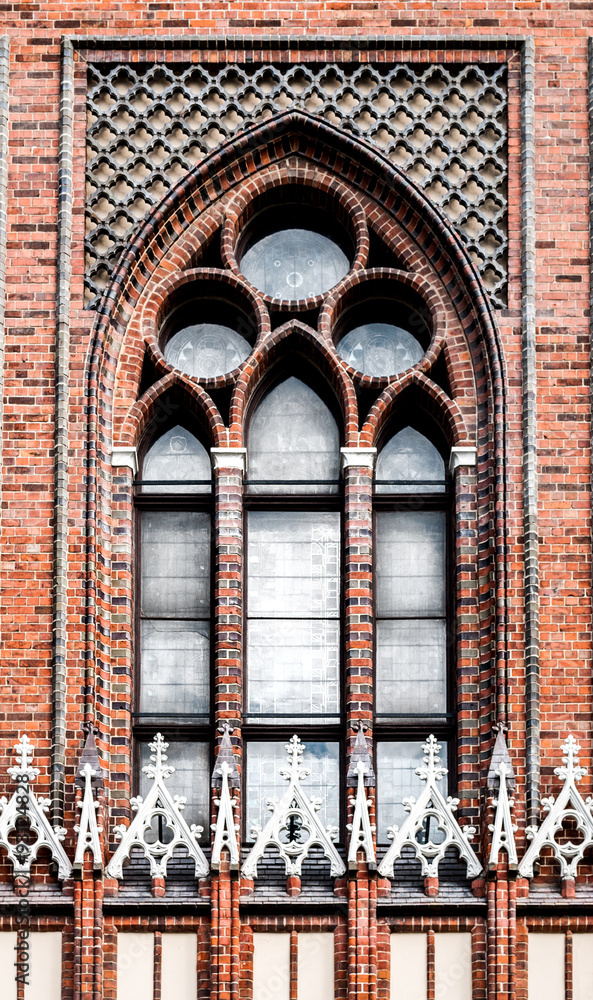 window on old gothic catholic church. Gothic window at the wall of the ...