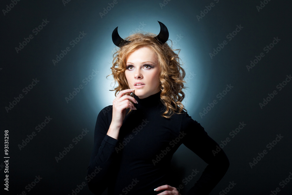 The beautiful young girl a devil in disbelief Stock Photo | Adobe Stock