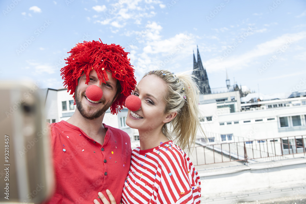 Germany, Cologne, young couple celebrating carnival dressed up as ...
