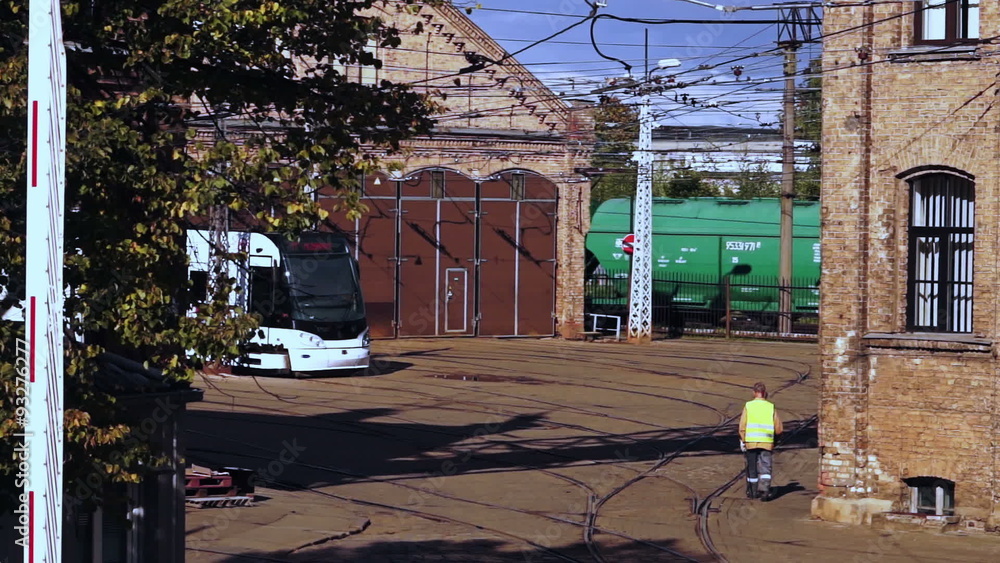 Of passing freight train composition to the old tram depot background ...