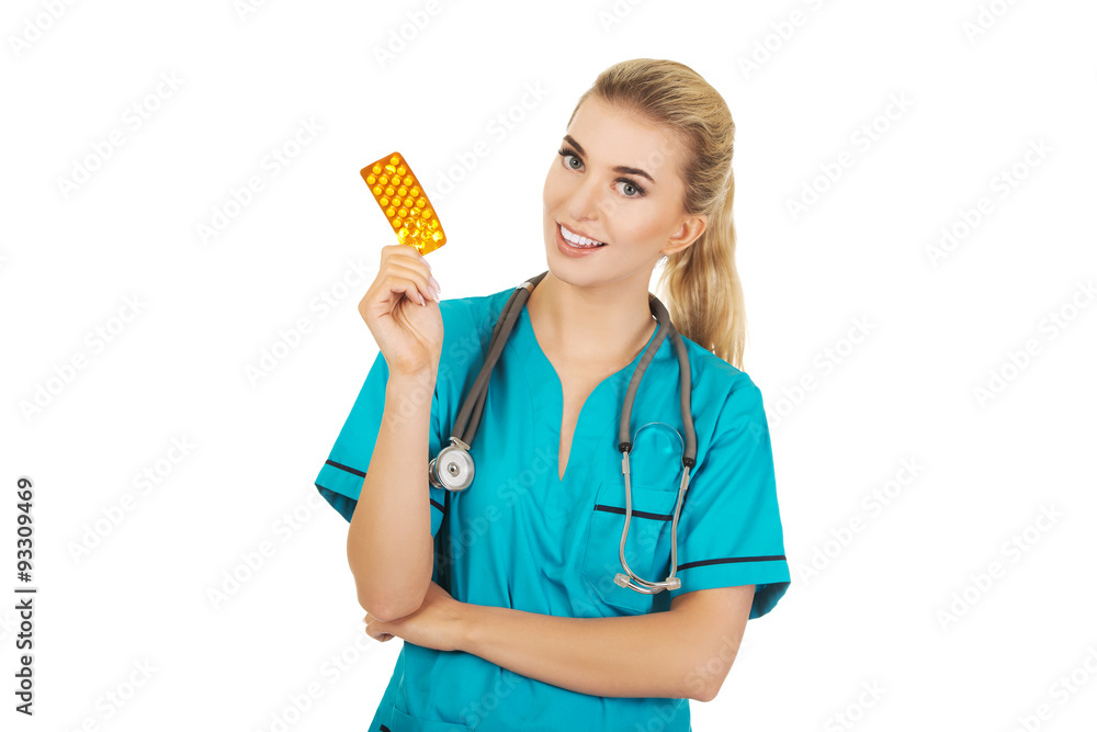 Young female nurse or doctor holding pills Stock Photo | Adobe Stock
