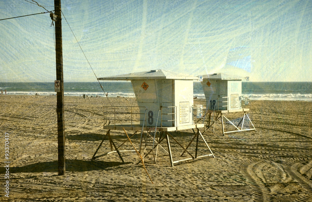 Foto de aged and worn vintage photo of lifeguard towers on beach do ...