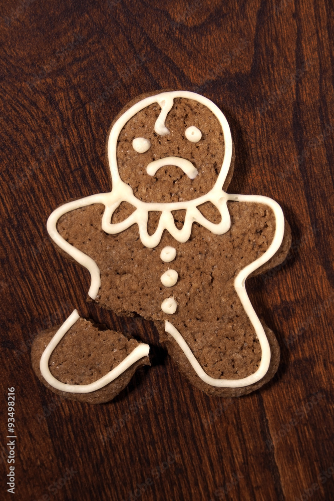 Sad gingerbread man - cookie with a broken leg. Stock Photo | Adobe Stock