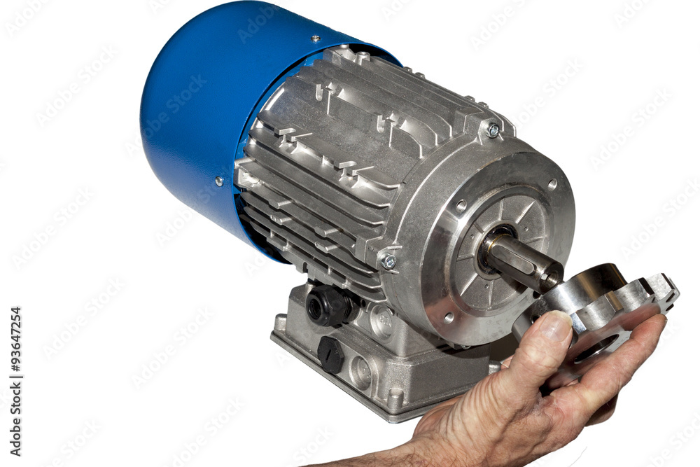 mechanical engineer fitting a sprocket to an electric motor driveshaft ...