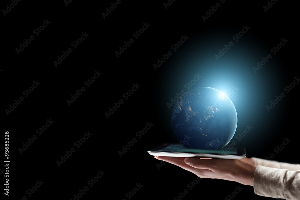 Computer tablet with a hand touching a touchscreen and Earth Stock ...