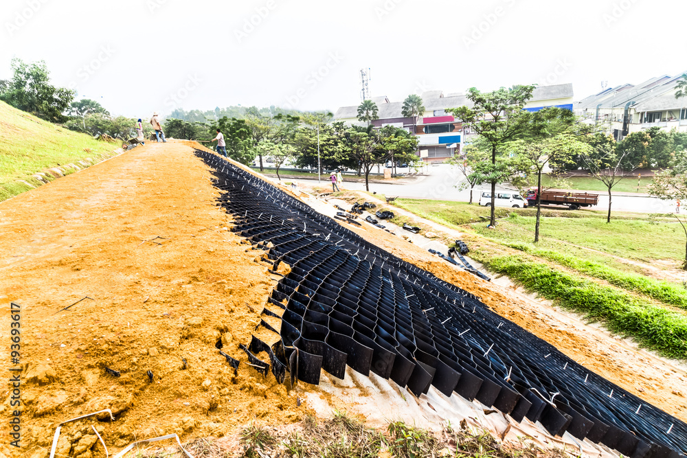 Slope erosion control with grids and earth on steep slope Stock Photo ...