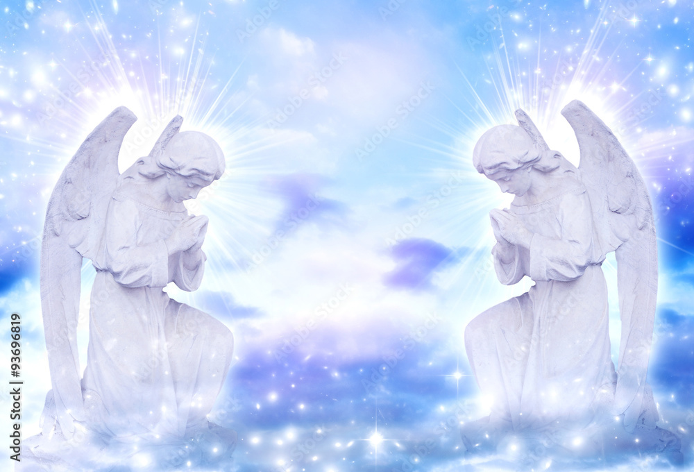 two praying angels with rays of light over blue sky with stars Stock ...