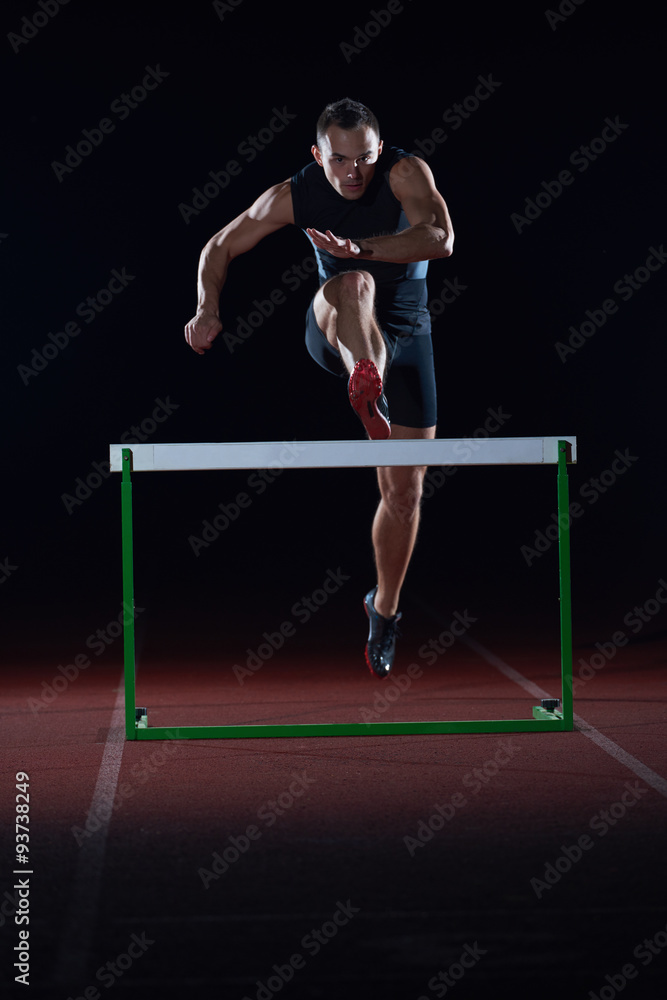 athlete jumping over a hurdles Stock Photo | Adobe Stock