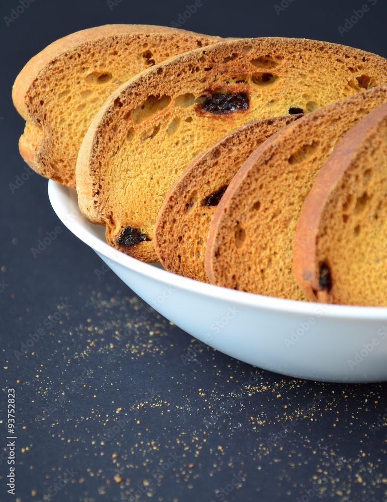 Rusk biscuit in white bowl on black background Stock Photo | Adobe Stock