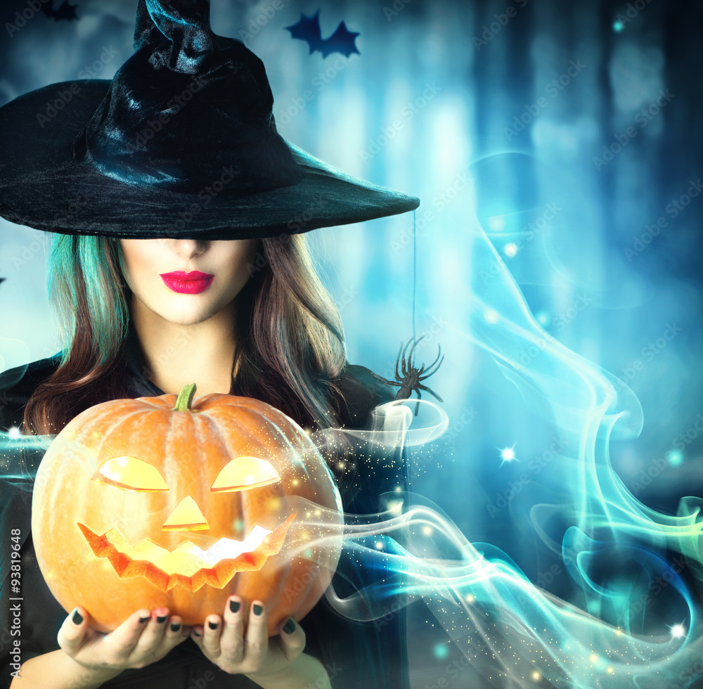 Halloween witch with a magic pumpkin in a dark forest Stock Photo ...