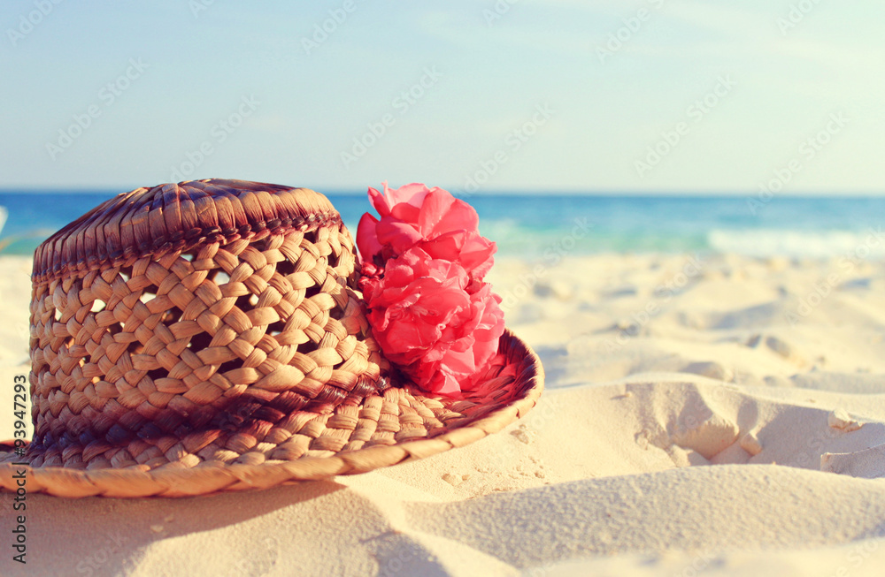 Handmade artisan caribbean straw hat and tropical pink flower on white ...