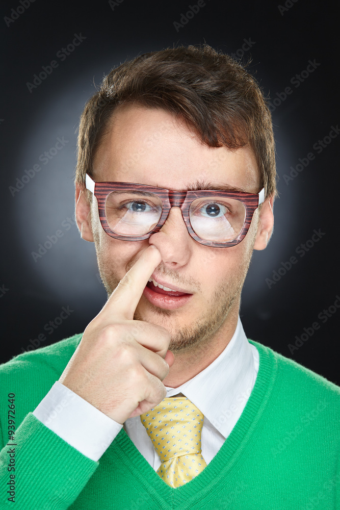 Close Up Portrait Of Nerd Holding A Finger In His Nose Stupid Person In Spotlight Geek Young