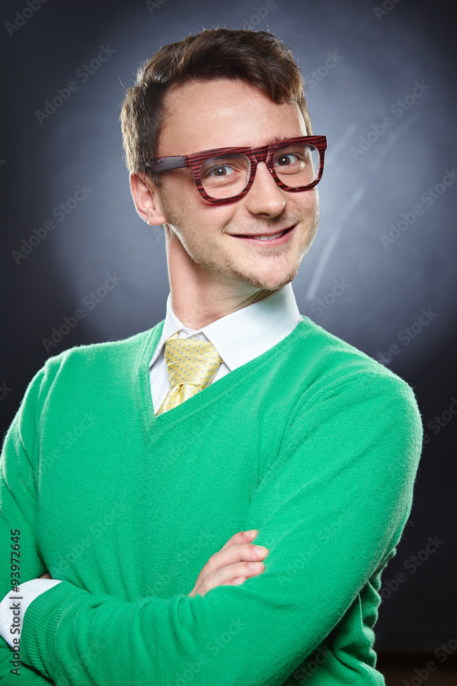 Weird smiling young man wearing eyglasses holding arms crossed on ...