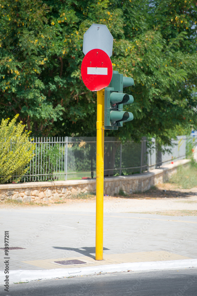 Traffic lights with stop sign on the street. Stock Photo | Adobe Stock