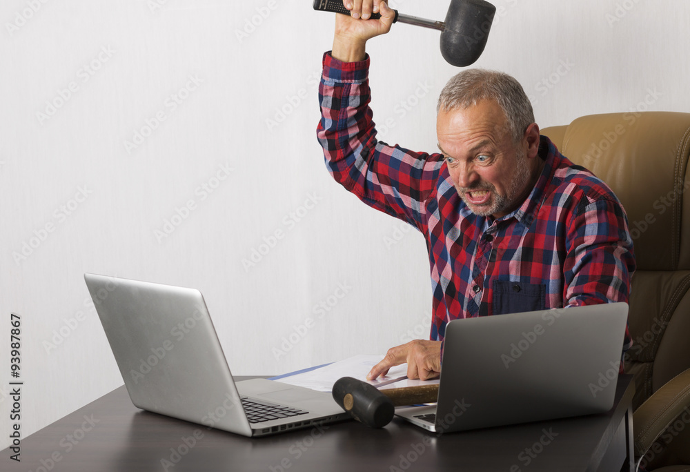 Angry man crashing laptop Stock Photo | Adobe Stock